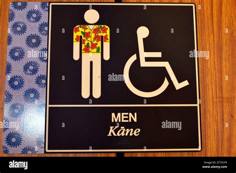A Whimsical Sign Announces The Mens Room In English And In Traditional