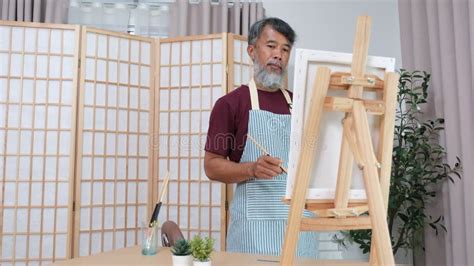 Elderly Uncle Passionately Painting As A Favorite Hobby In His Free Time Stock Video Video Of