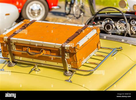Old Leather Suitcase On The Luggage Rack Of Yellow Vintage Car Stock