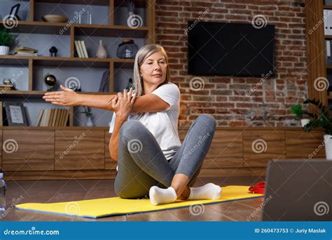 Gray Haired Happy Mature Woman Doing Gymnastics And Yoga At Home Online