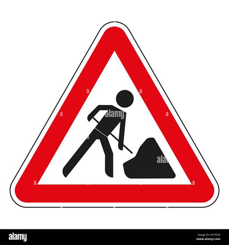 A Road Sign With A Red Triangle Indicating Construction Work In