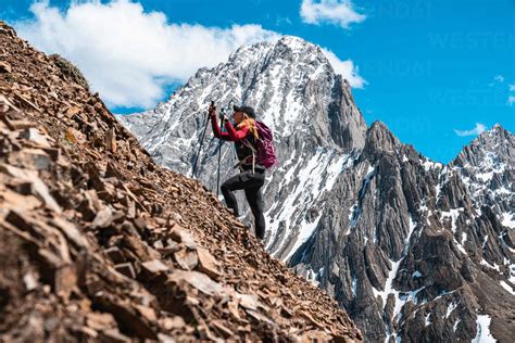Hiker Climbing Up Rocky Scree Slope On Grizzly Peak Mount Even Thomas