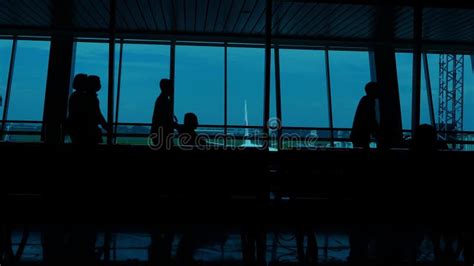 Against A Windows Warm Glow Figures In Motion Of Silhouettes Of