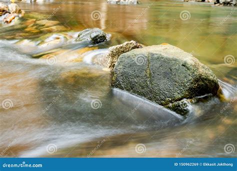 Closeup Of Large Stones Set In The Water Blocking The Passage Of Water