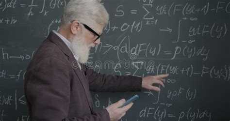 Senior Man Scientist Checking Mathematics Formula On Chalkboard And
