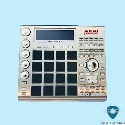 A Silver Electronic Device With Buttons And Knobs On The Front Against A Blue Background