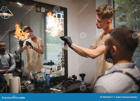 A Delightful Barber Spraying Fire Flames With A Hairspray And Tools For