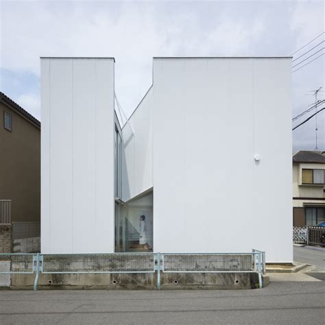 Timber Frame Projects Into Rooms And Stairwell Of Compact Kyoto Home