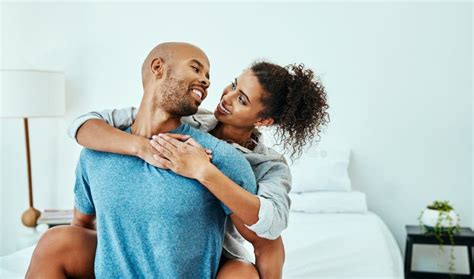 Come Back To Bedan Affectionate Young Couple In Their Bedroom Stock