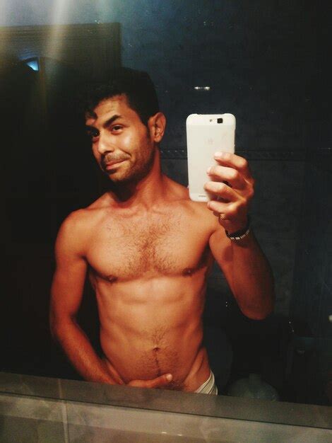 Premium Photo Reflection Of Shirtless Man Taking Selfie In Mirror