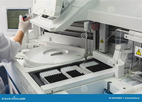 Lab Tech Loading Samples Into A Chemistry Analyzer Royalty Free Stock