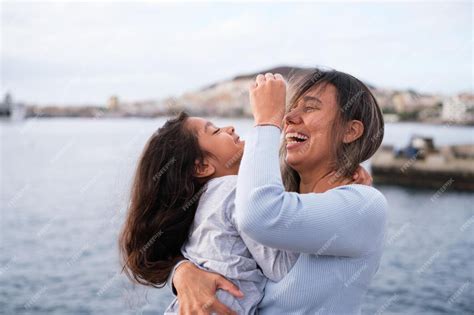 Premium Photo Glad And Happy Mother And Daughter Hugging And Laughing