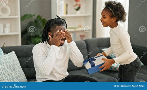African American Father And Daughter Surprise With T Sitting On Sofa