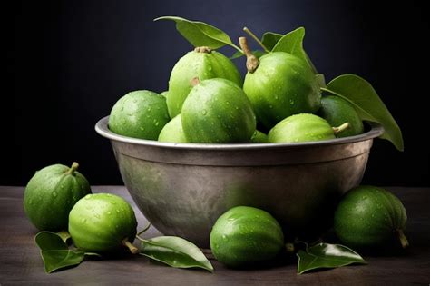 Premium Photo Green Feijoas In A Metallic Pot On Grey