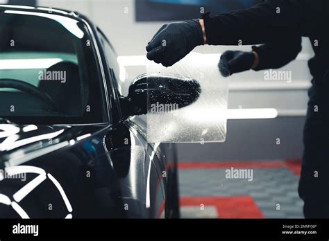 The Process Of Installing Ppf On The Side Mirror Anti Gravity Protection Professional Male