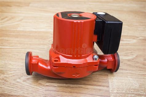 Red Circulation Pump For Heating System Lies On The Floor Stock Image