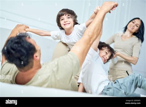 Portrait Of Cheerful Little Latin Boy Having Fun Playing With His
