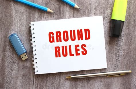 Top View Of The Workspace Notepad With Ground Rules Text Pen Pencils