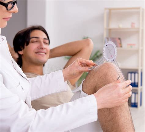 Female Doctor Checking Patientand X27s Joint Flexibility With Goniomet