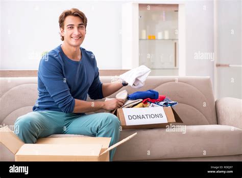 Concept of charity with donated clothing Stock Photo - Alamy