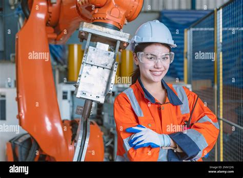 Portrait Happy Woman Worker With Robot Assembly Machine In Modern Metal