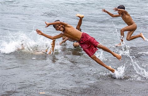 Indonesian Boys Jumping In The Sea