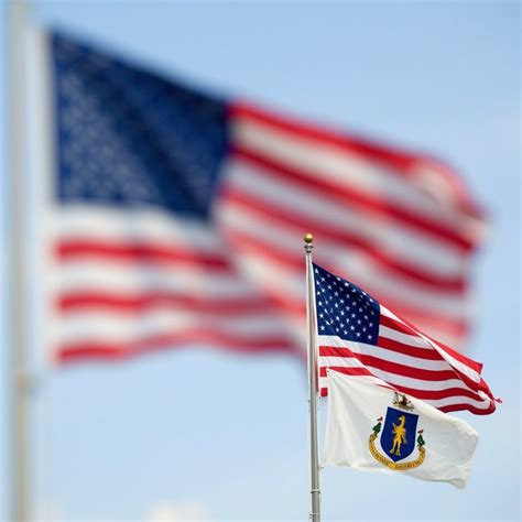 A Smaller Massachusetts State Flag And The U S Flag Are Placed Side By