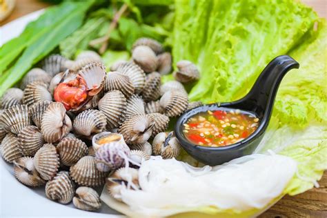 Cockle Shellfish Seafood Plate With Fresh Vegetable Herbs And Spices On