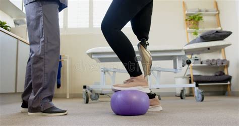 Balancing On Exercise Ball Person With Prosthetic Leg Receiving