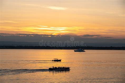 Tour Boats And A Yacht On The Sea At Sunset Near Ortigia In Syracuse