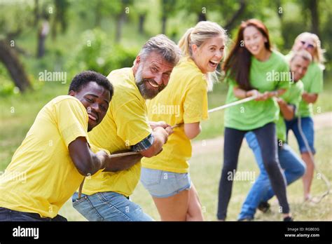 Young People Enjoy Tug Of War As An Exercise In The Team Building