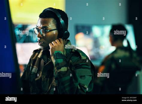 Military Control Room And Man On Computer In Office Data Center And Monitor For Technical