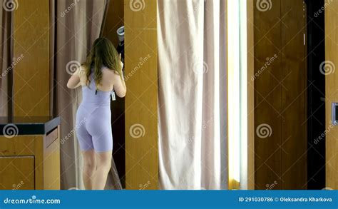 Young Girl In Fitting Rooms Puts On Sports Tight Suits Clothes New With