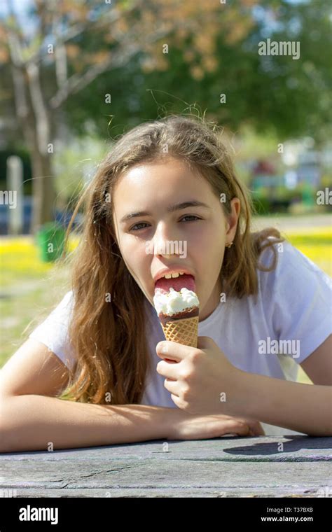Beautiful Teen Girl Eating Ice Cream In Waffle Cone In Summer Stock
