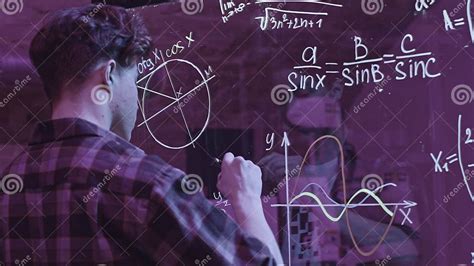 Young Man Solves Mathematical Equations On Blackboard Media Stock