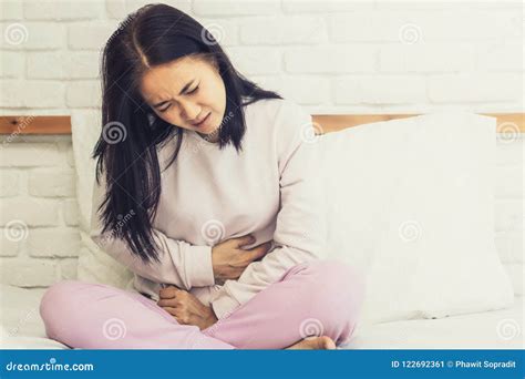 Beautiful Attractive Asian Woman Wearing White Shirt Sitting On Bed