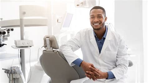 Highly Qualified Young Dentist Posing At Modern Clinic Stock Image