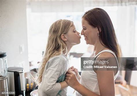 Mother Daughter Kissing Lips Stock Fotos Und Bilder Getty Images
