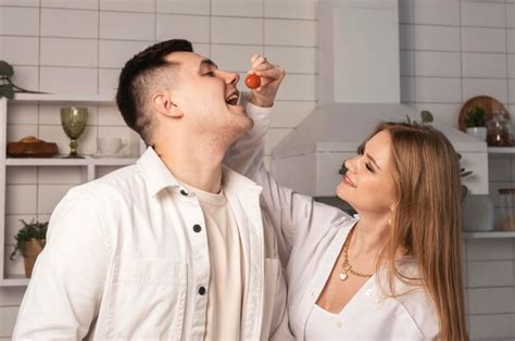 Premium Photo Woman Treating Feeding Man Wife Putting Cherry Tomato Into Man S Mouth Love