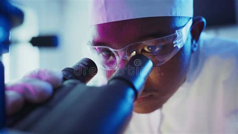 Scientist Looking Through Microscope In Laboratory Stock Video Video