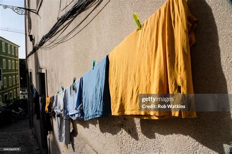 Laundry Hung Out On Washing Line At Street Level On Pavement City Life