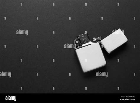 Gray Metallic Cigarette Lighter On Black Background Top View Space