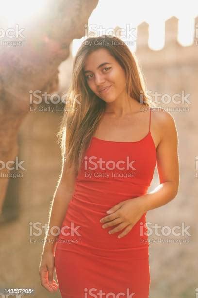Girl With Tight Red Dress And Long Straight Hair Posing In Toledo Stock