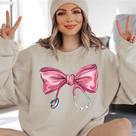 Dopashirt Pink Coquette Nurse Stethoscope Bow Sweatshirt Cute Nurse