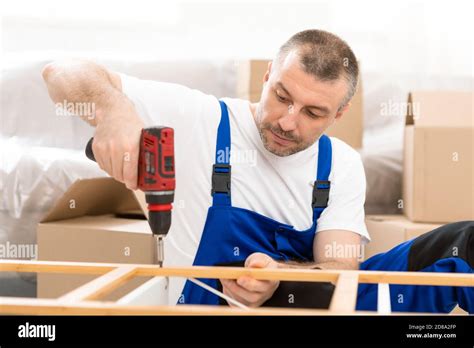 Furniture Assembler Assembling Cabinet Working Using Electric Drill