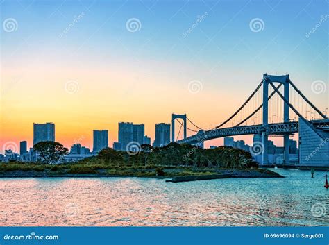 City Skyline And Rainbow Bridge Across Tokyo Bay In Sunset Odaiba