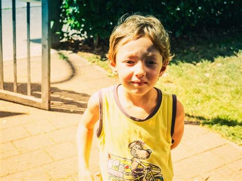 Premium Photo Portrait Of Boy Standing By Gate
