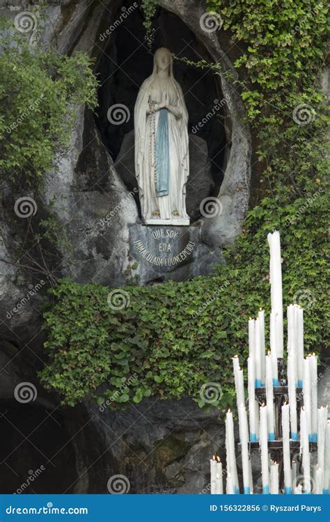Statue Of Our Lady Of Immaculate Conception With A Rosary In The Grotto