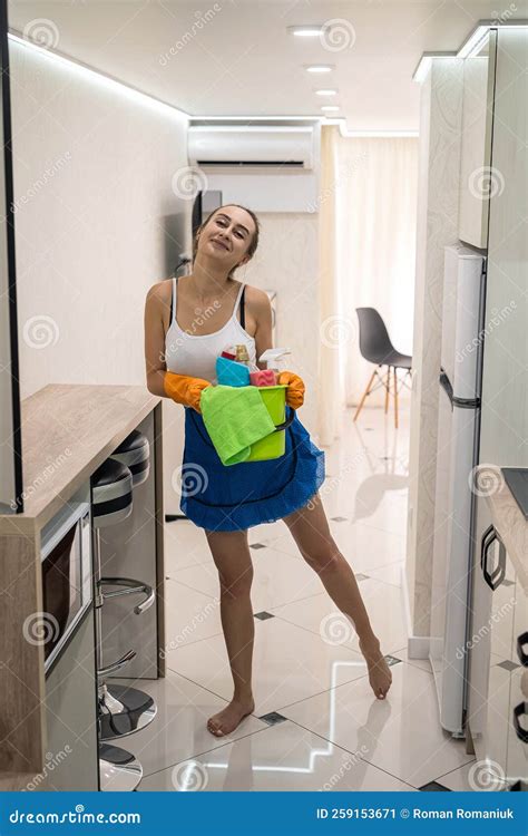 Pretty Young Housewife Doing The Housework In Her Kitchen Stock Image