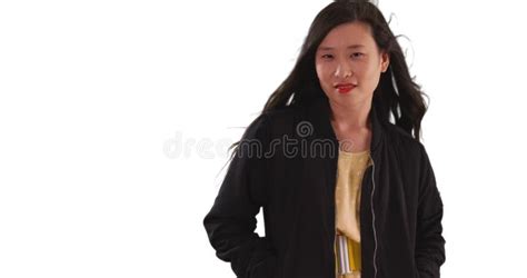 Portrait Of Relaxed Chinese Girl Looking At Camera On Green Screen